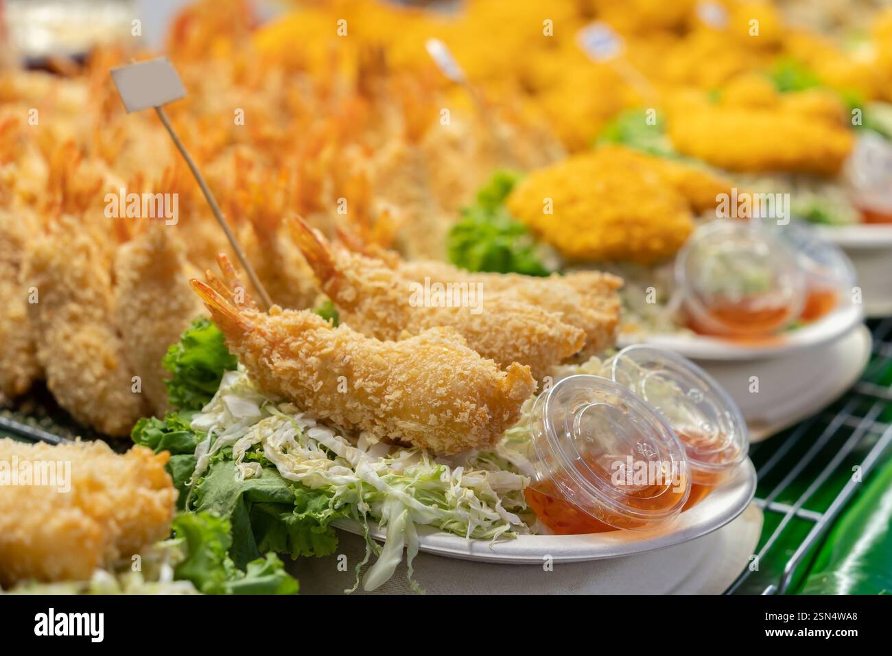 Breaded prawn with chili sauce. It features prawns that are coated in a ...