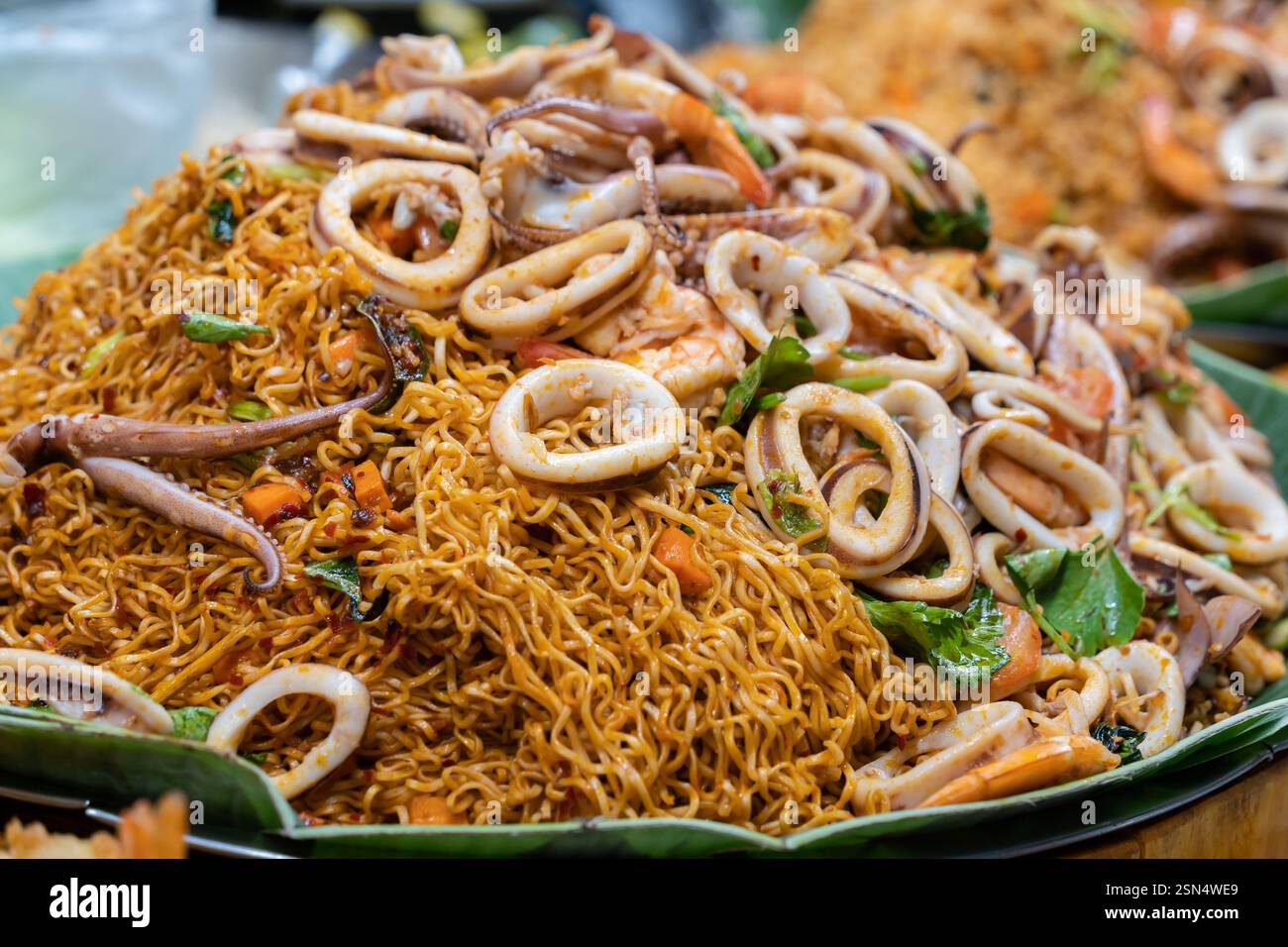 Close-up view of fried instant noodles with succulent shrimp, squid ...