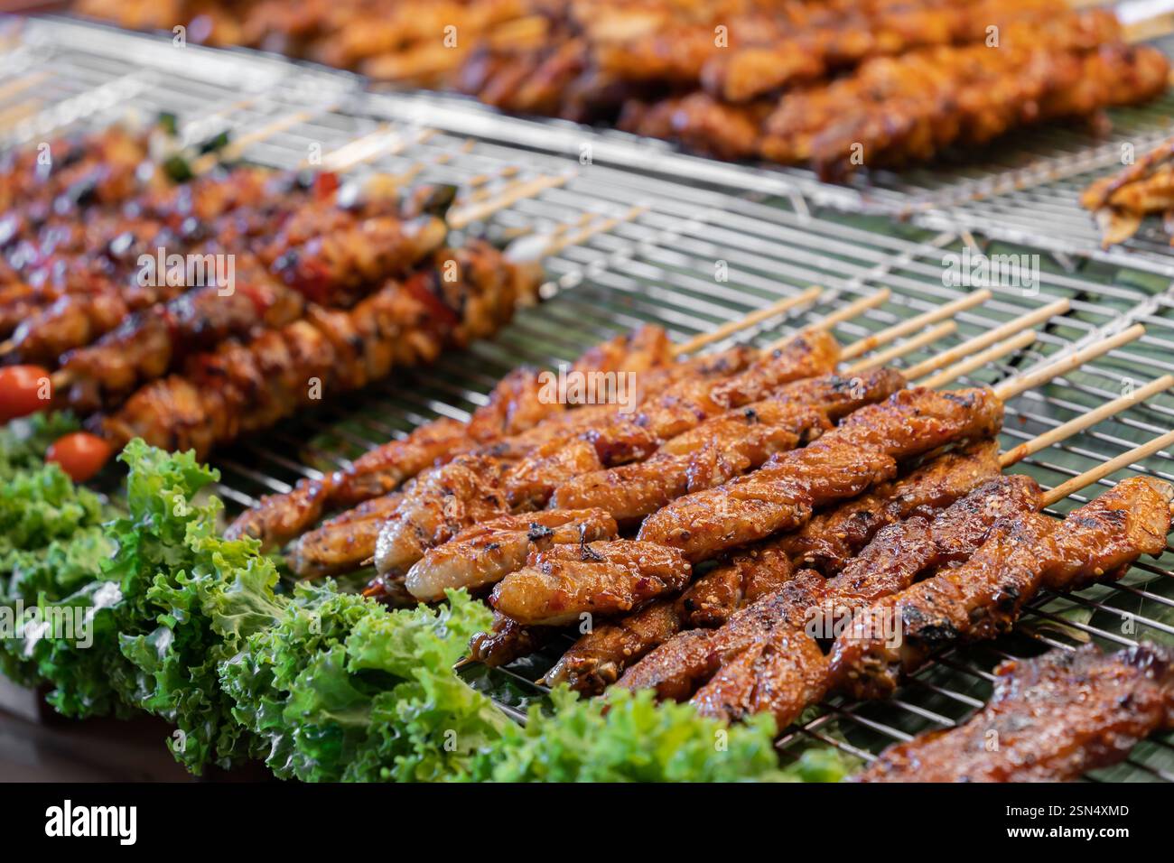 A variety of barbecue meat skewers are being sold at the food stall ...