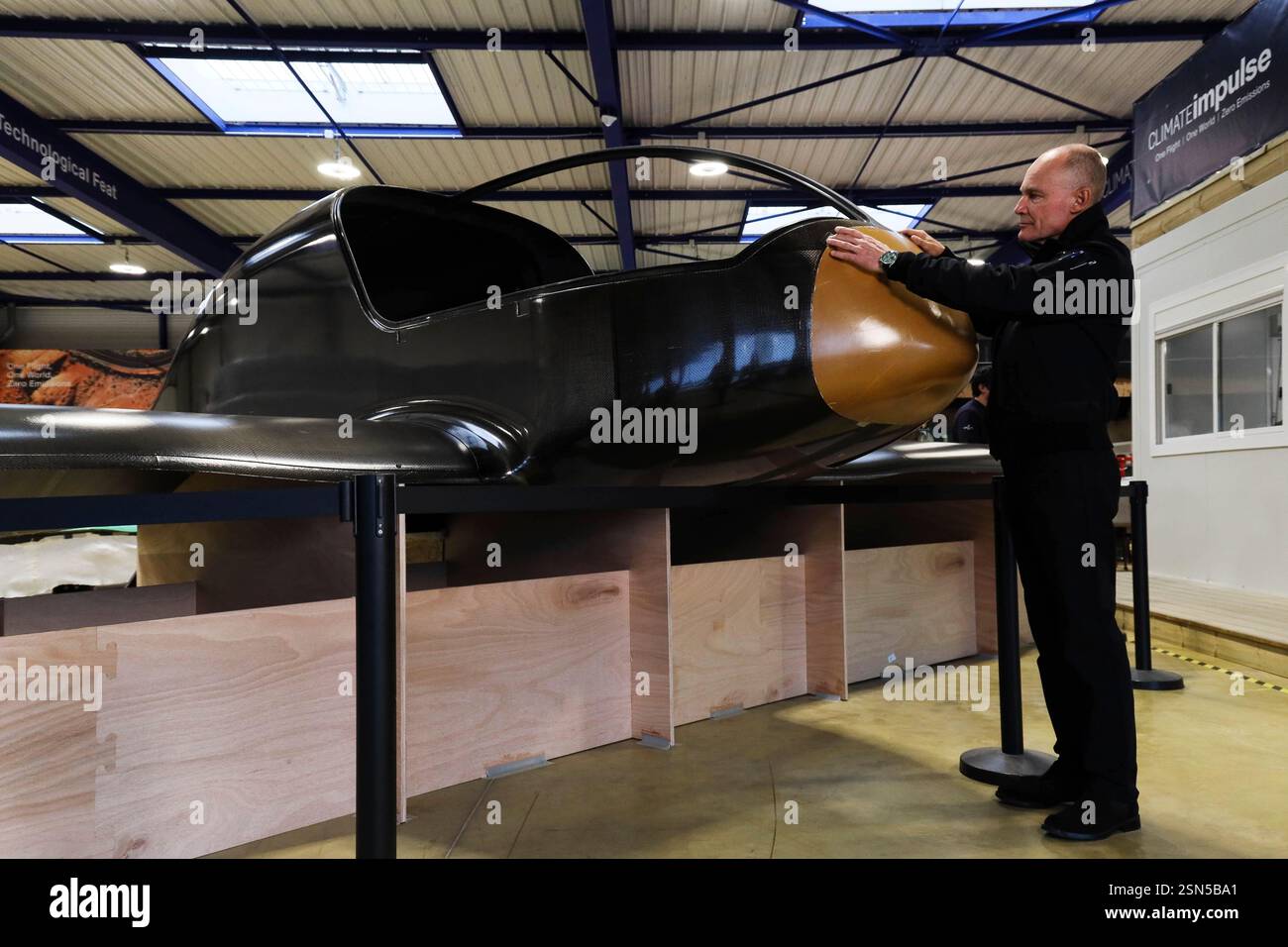 Swiss aviation pioneer Bertrand Piccard touches Climate Impulse, a ...