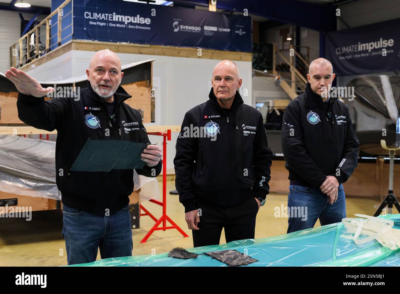 Swiss aviation pioneer Bertrand Piccard, center, Raphael Dinelli, left ...