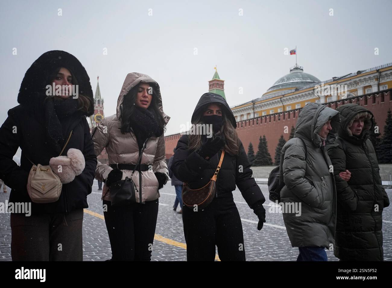 People walk on the Red square in Moscow, Russia, Thursday, Feb. 13 ...