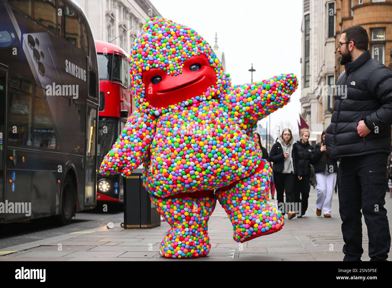 EDITORIAL USE ONLY The 'Gummy Monster' mascot hands out samples of ...