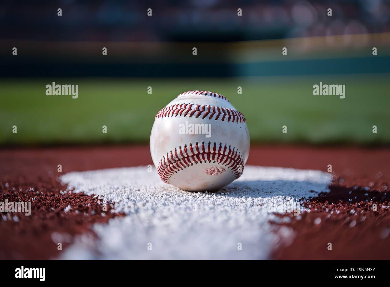 A baseball sits on the pitcher's mound with a clear view of the green ...