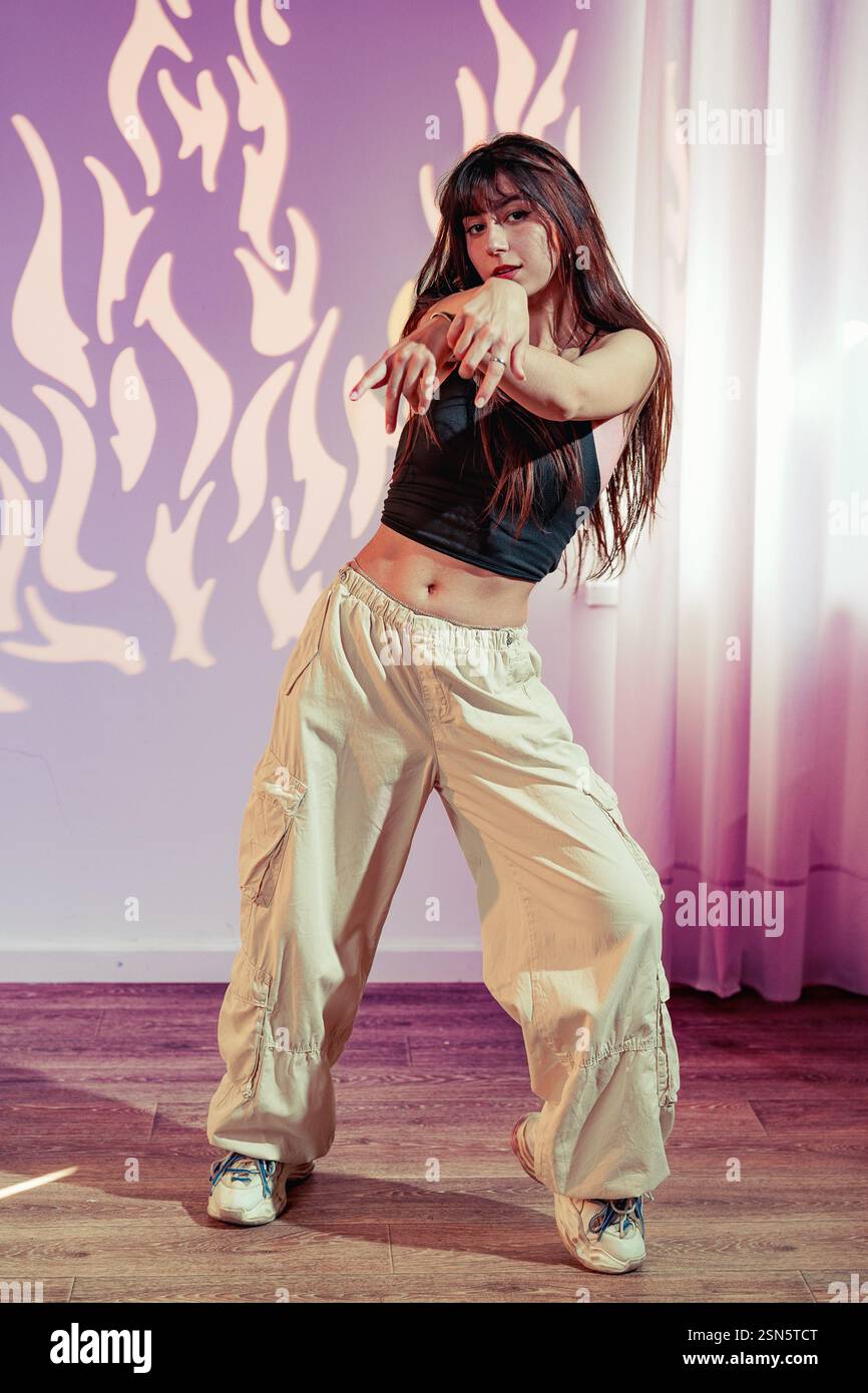 Dancer showcases dynamic movement in stylish urban attire during ...