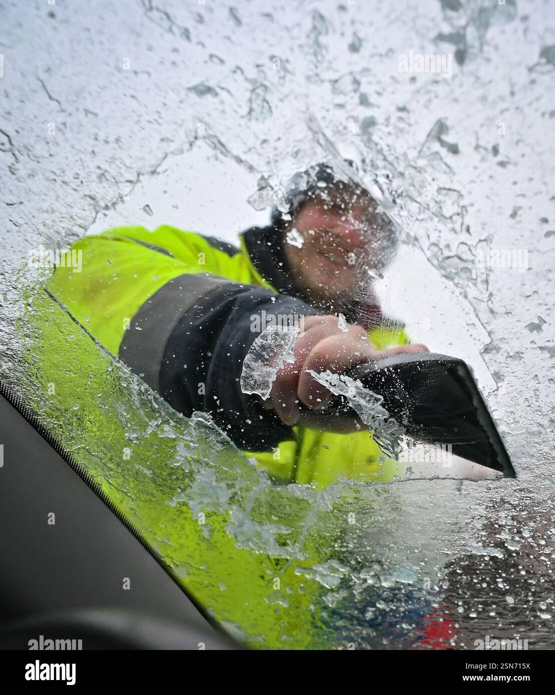 Trest, Czech Republic. 13th Feb, 2025. Driver scraping ice from the car ...