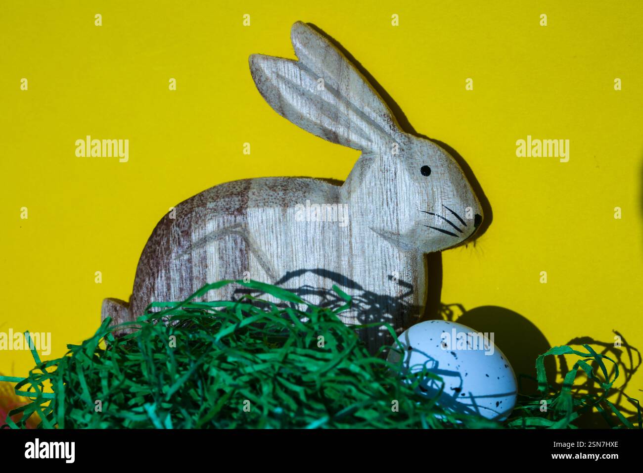 Easter bunny with yellow background and green decoratio Stock Photo - Alamy