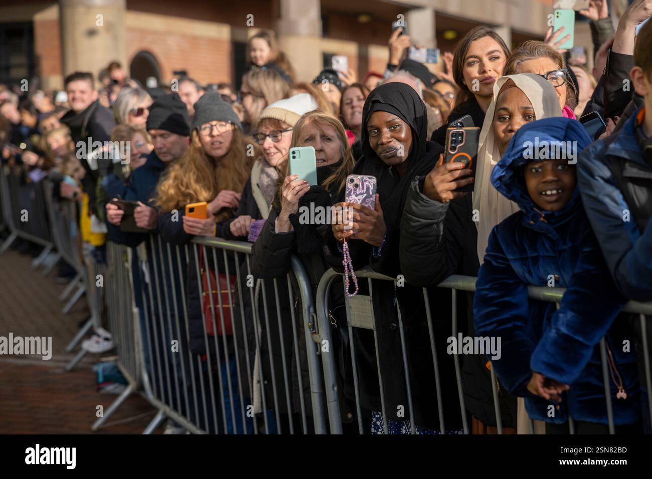 Members of the public wait for King Charles III and Queen Camilla as ...
