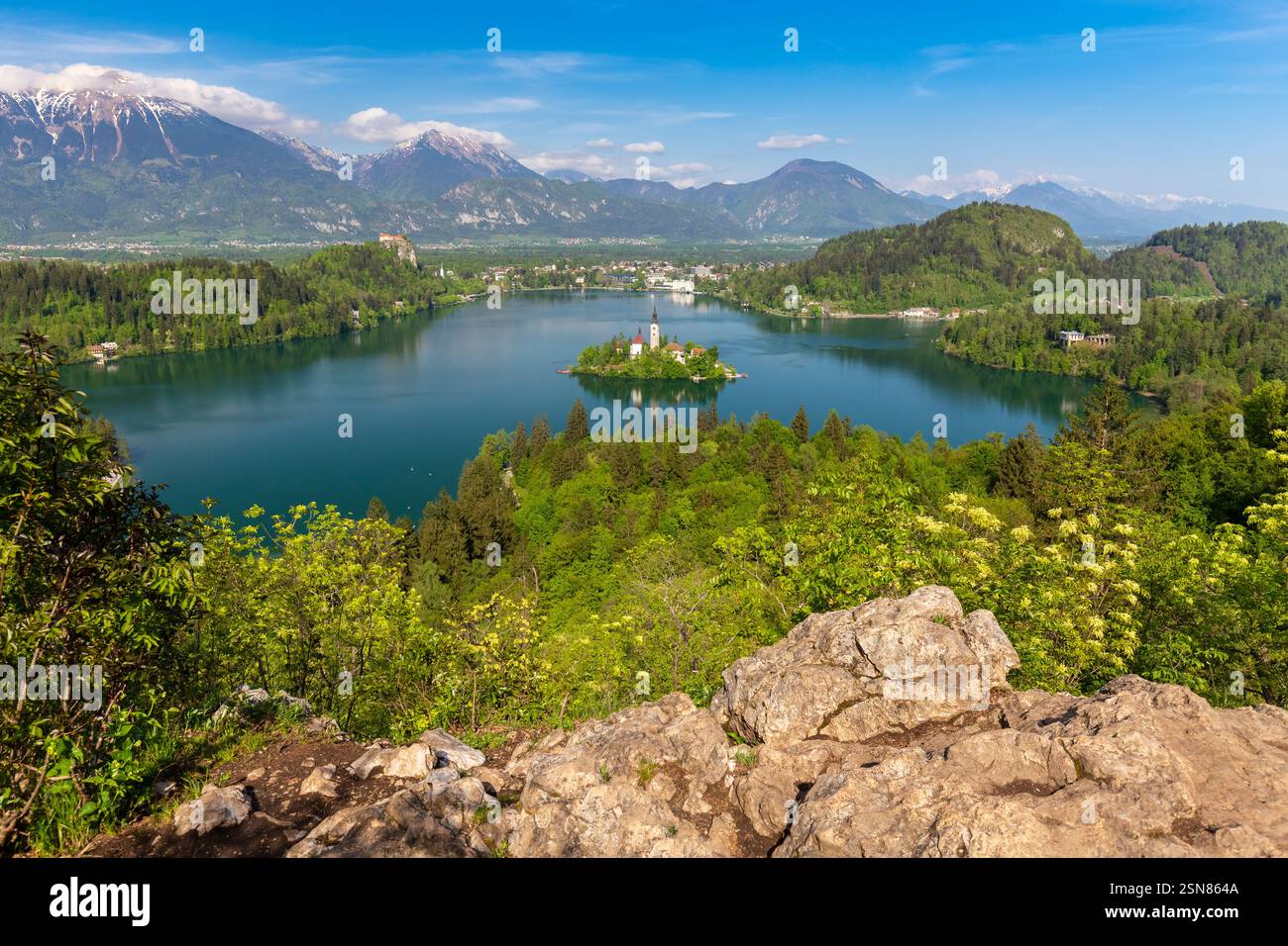 View of lake Bled at in spring with the small island and Assumption of ...