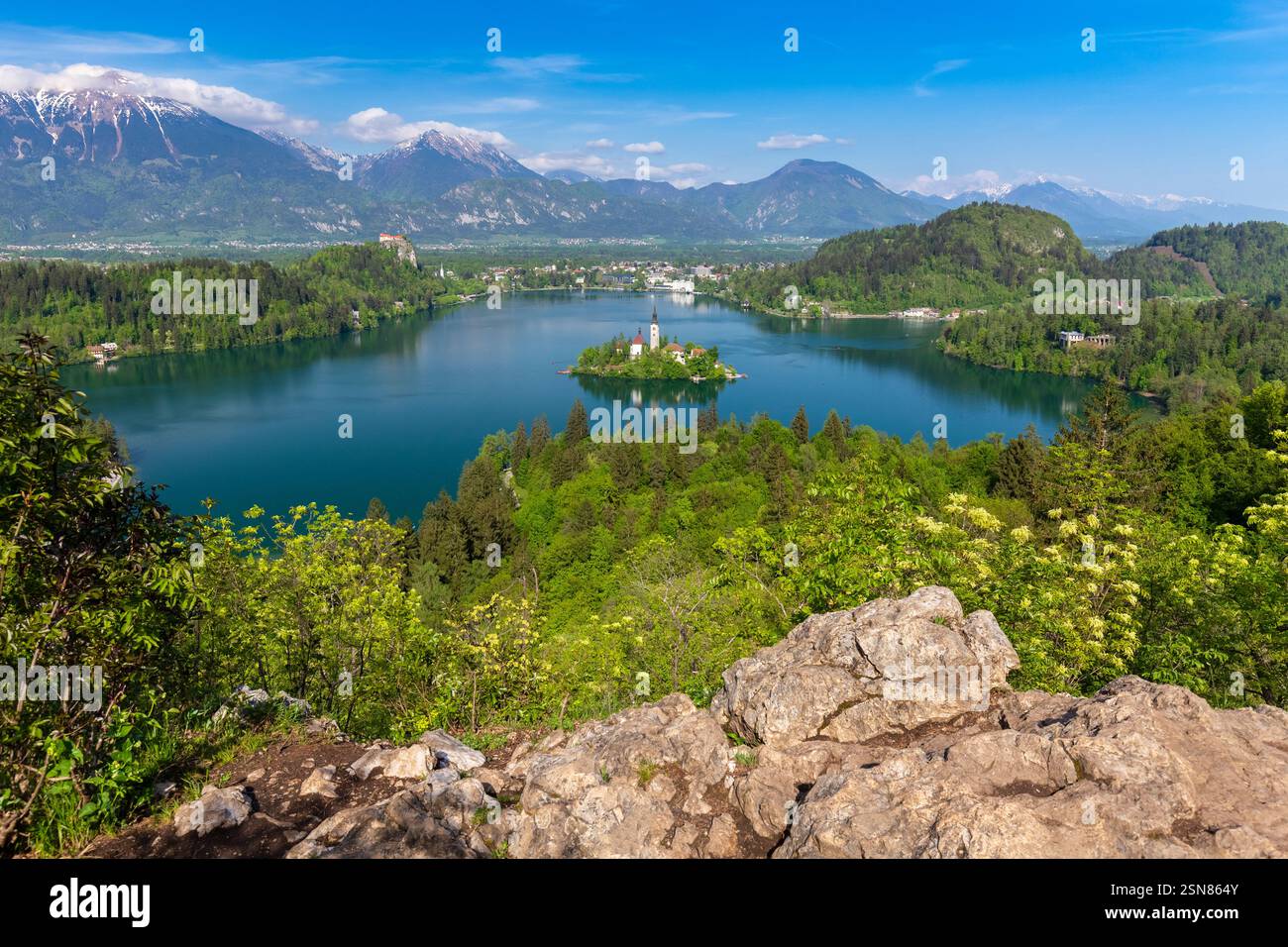 View of lake Bled at in spring with the small island and Assumption of ...