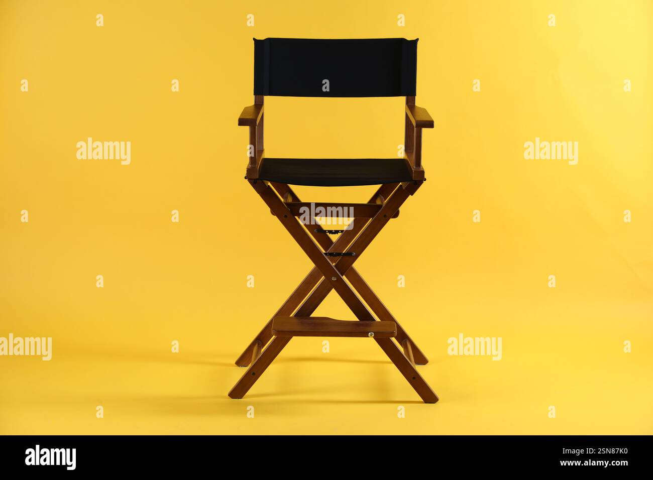 One empty director's chair on yellow background Stock Photo - Alamy