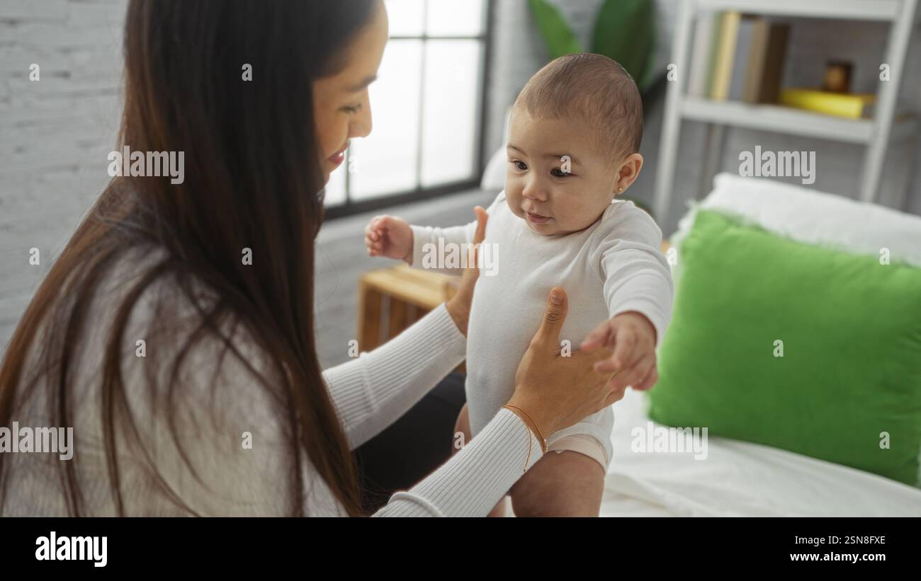 Woman lovingly holding baby hi-res stock photography and images - Alamy