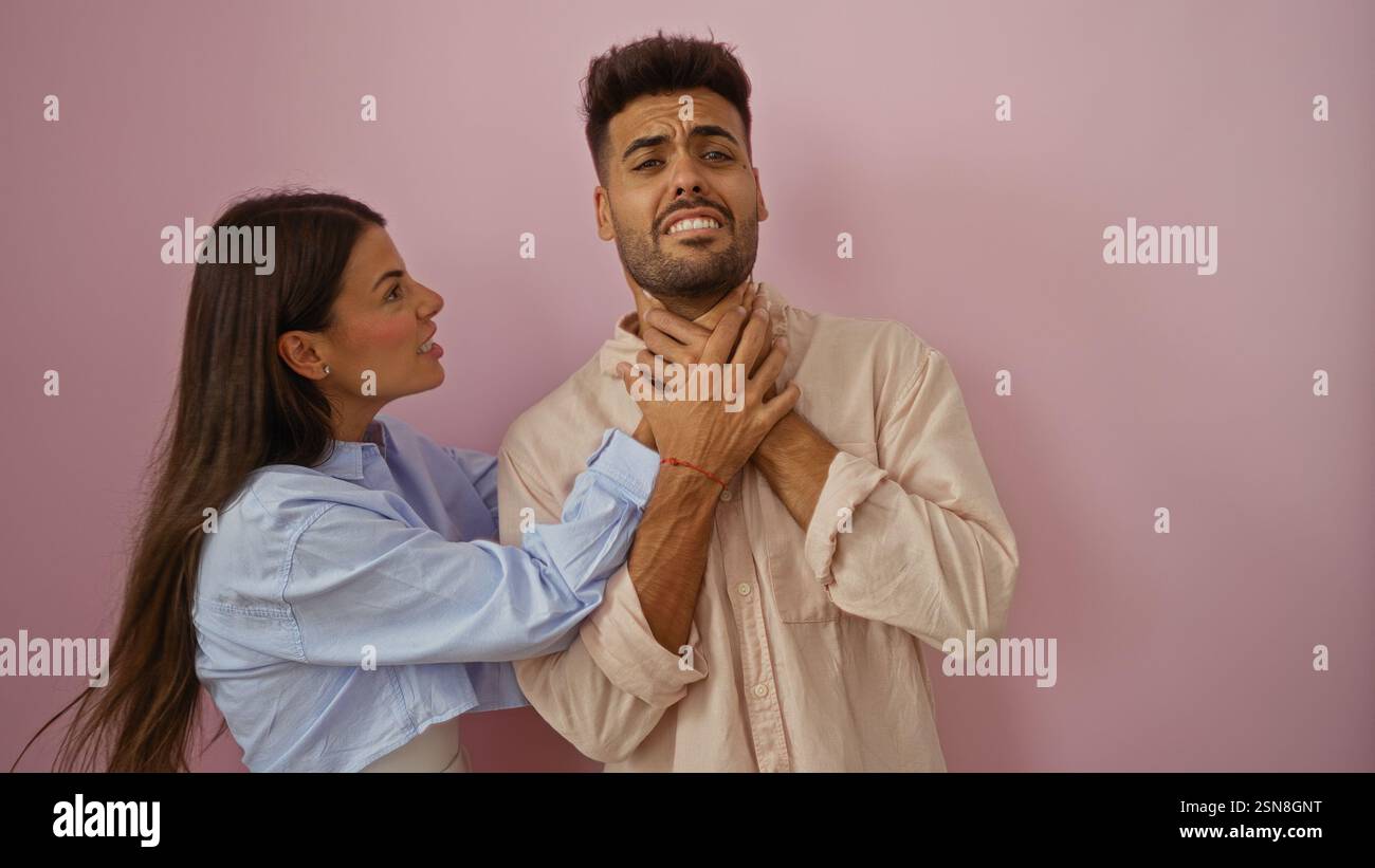 Woman choking man against pink background, displaying aggressive ...