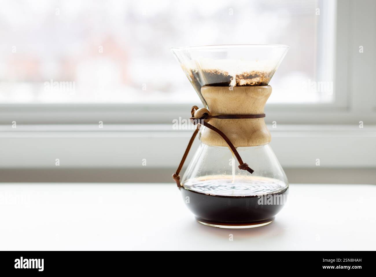 Hand-drip coffee dripper using a paper filter Stock Photo - Alamy
