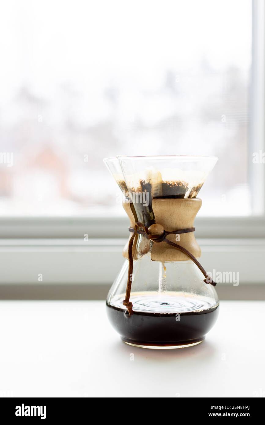 Hand-drip coffee dripper using a paper filter Stock Photo - Alamy
