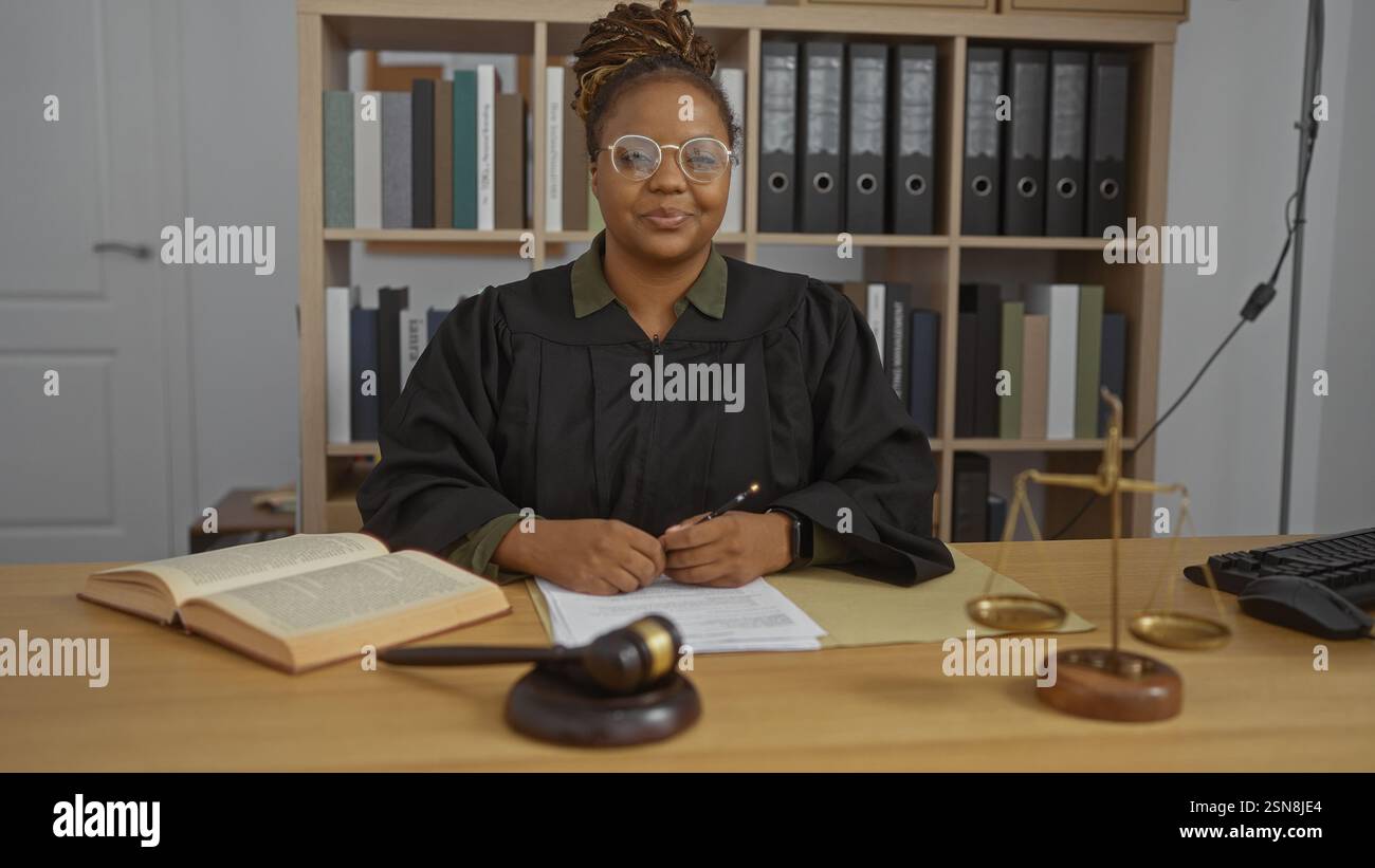 African american woman judge in courtroom wearing glasses sitting at ...