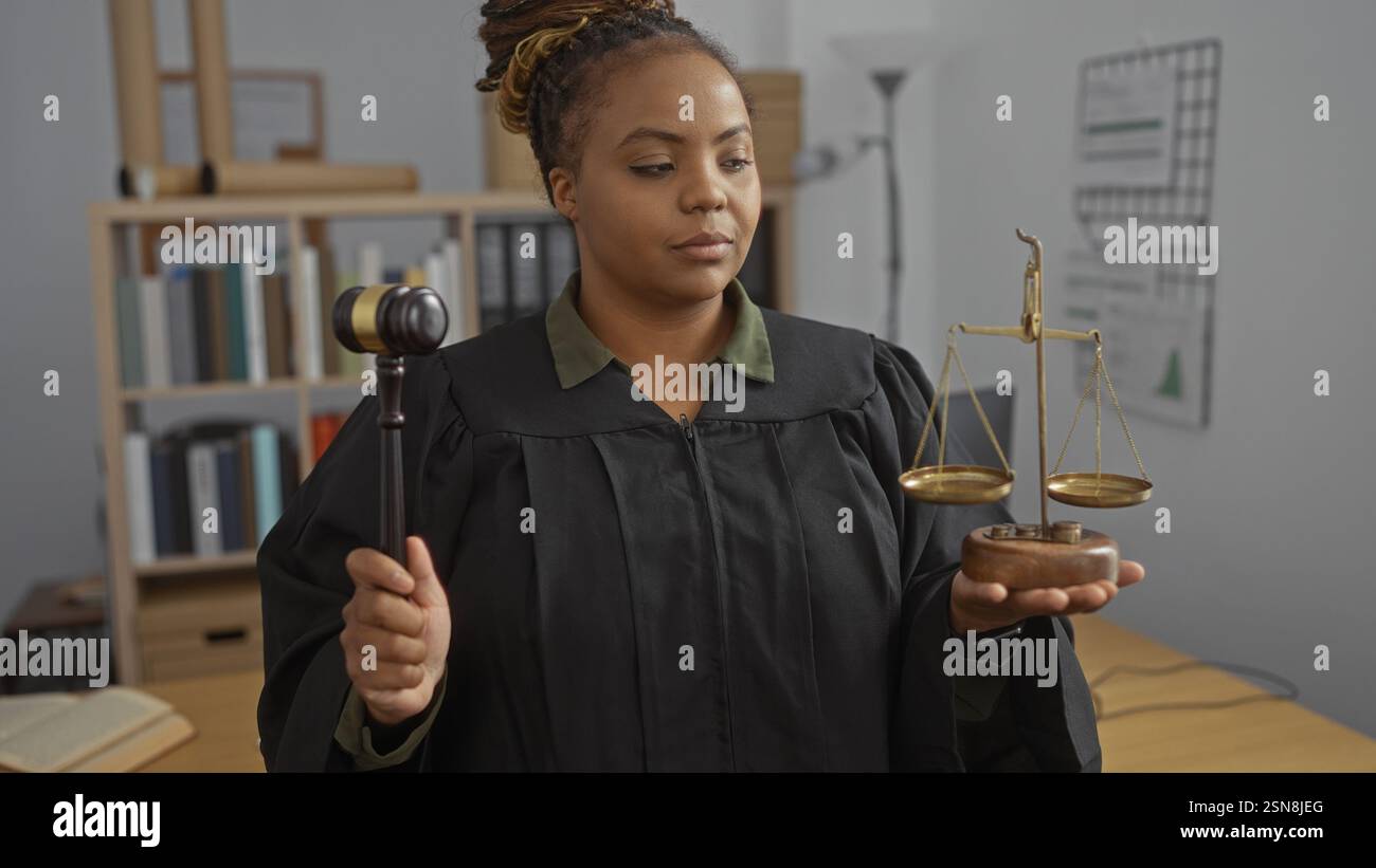 Woman holding gavel in office while balancing scales of justice ...