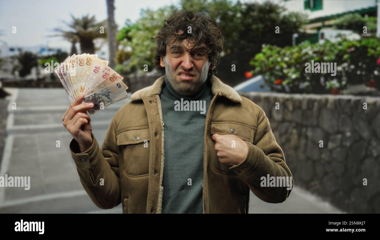 Hispanic man holding turkish lira banknotes on a city street displaying ...