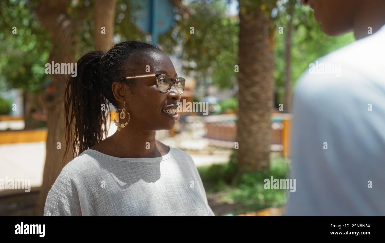 Mother and son sharing a loving moment in a city park, depicting ...