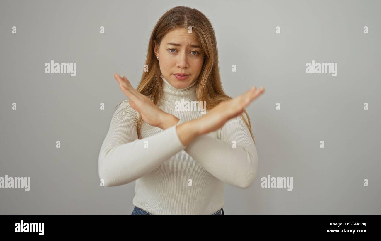 Woman making stop gesture while expressing disapproval over white ...