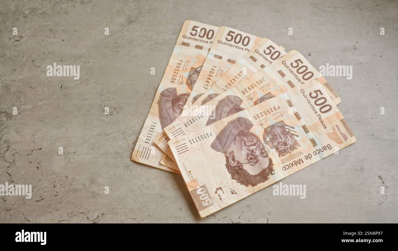 Mexican pesos banknotes on a concrete surface, showcasing 500 pesos ...