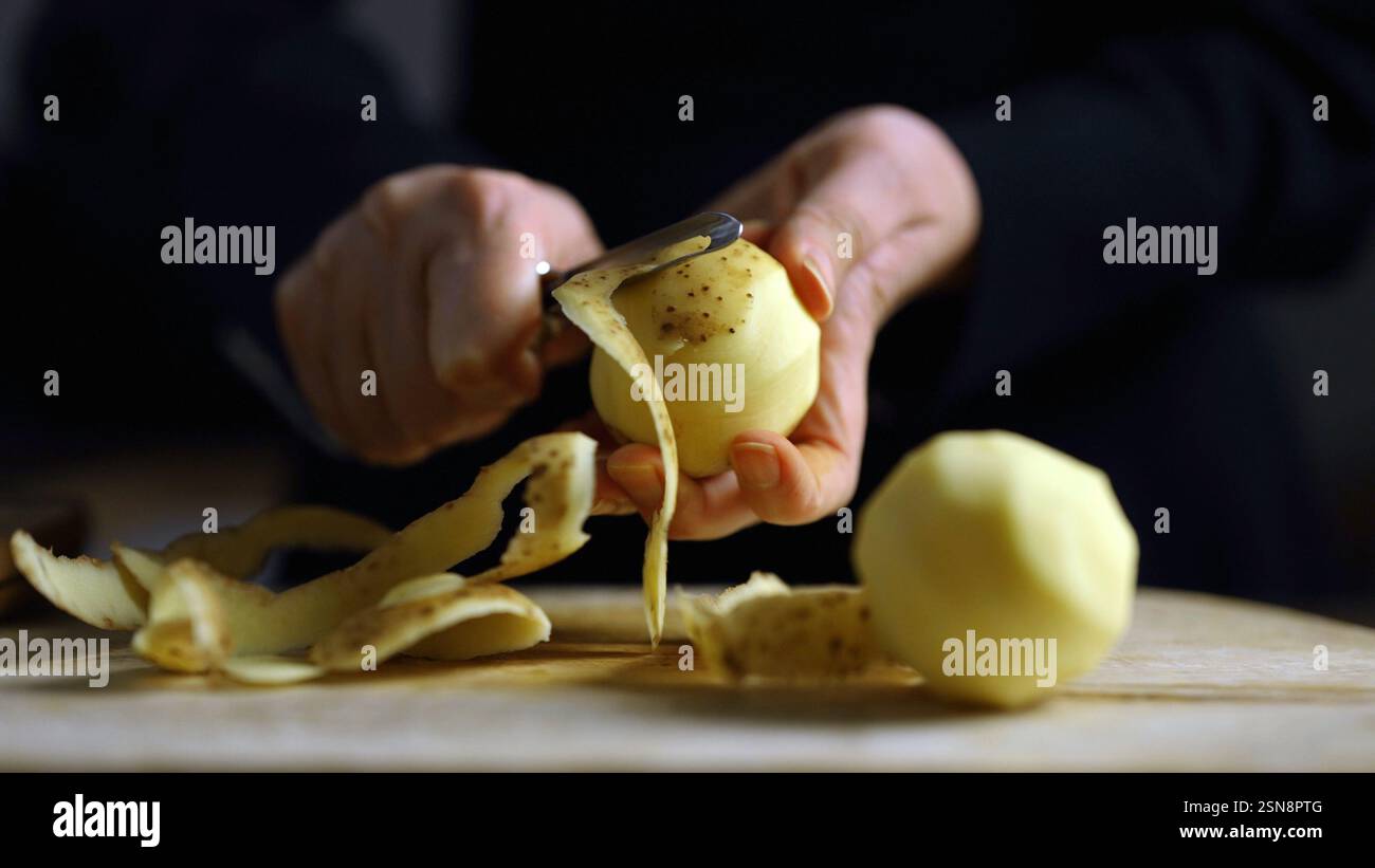 Hand using peeler peel fresh hi-res stock photography and images - Alamy