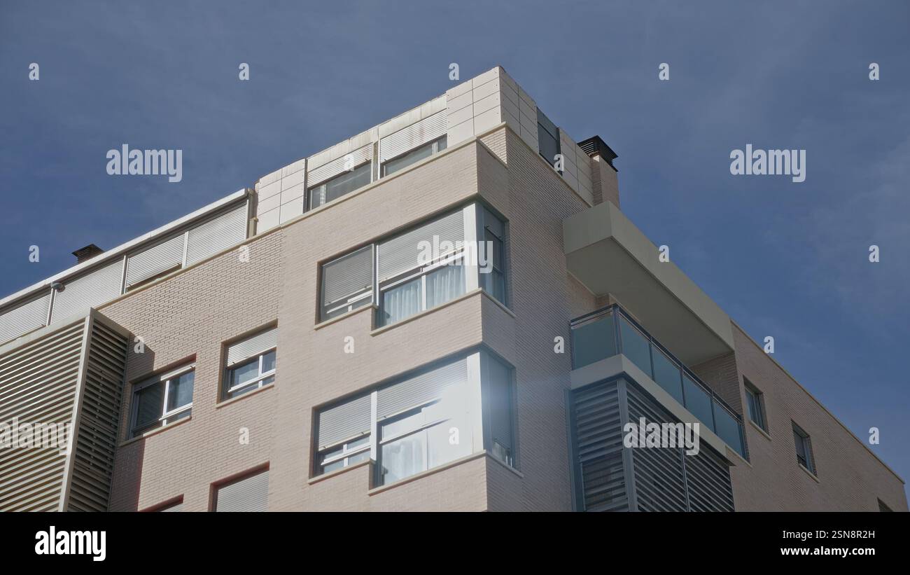 Modern apartment building corner view with clear blue sky background ...