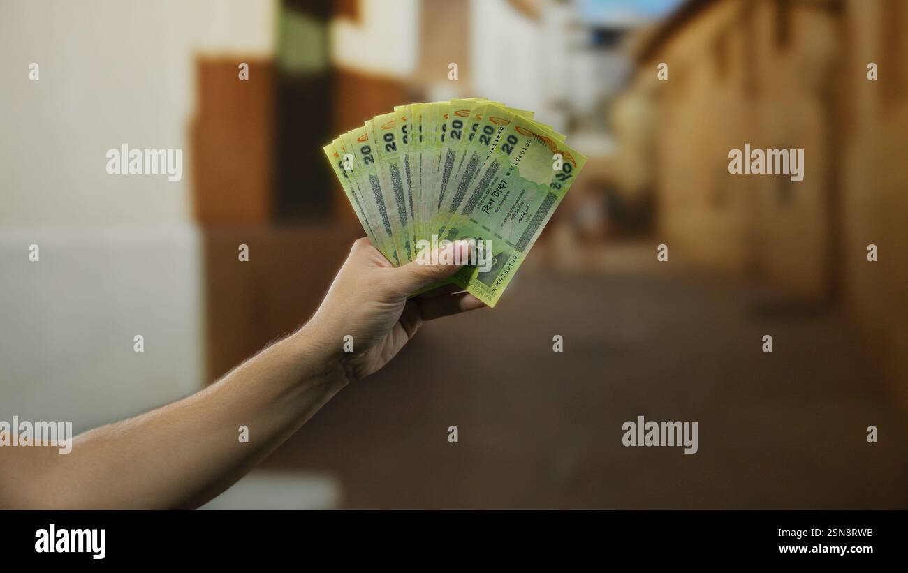 Hand holding bangladeshi banknote outdoors hi-res stock photography and ...