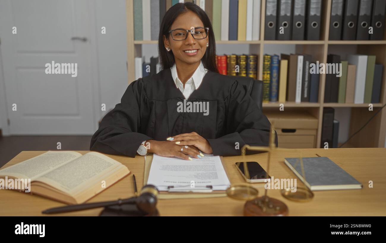 Young hispanic female judge seated at her desk in an office, surrounded ...