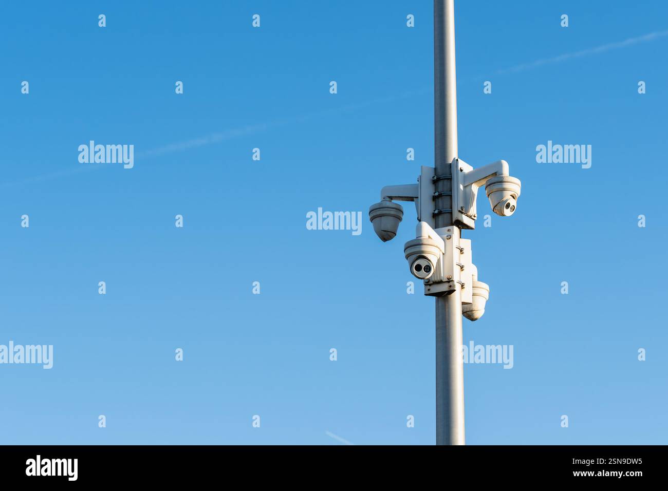Multiple surveillance cameras in city attached to a tall metal pole for ...
