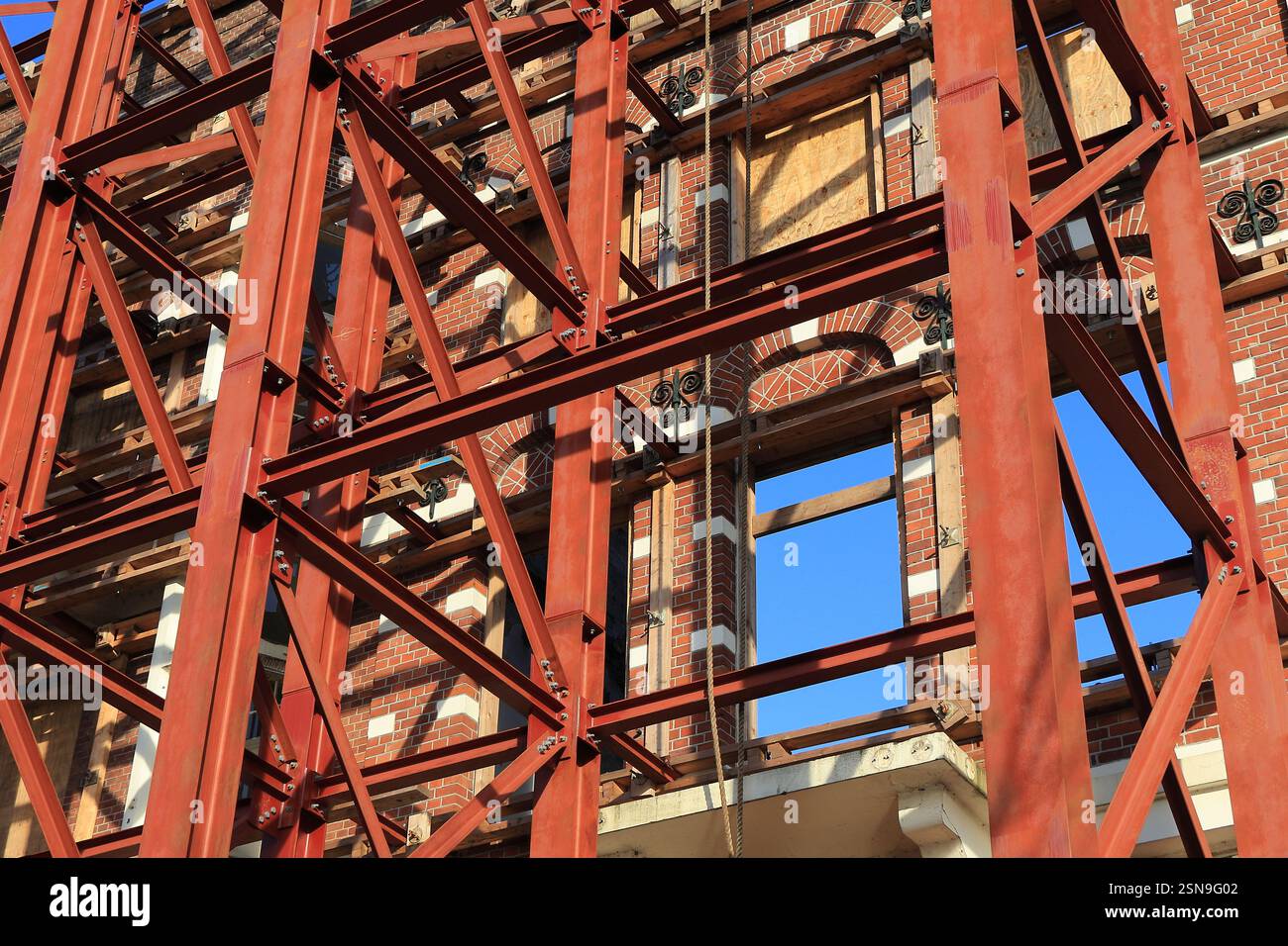 Brick building facade with metal support structure and open window with ...