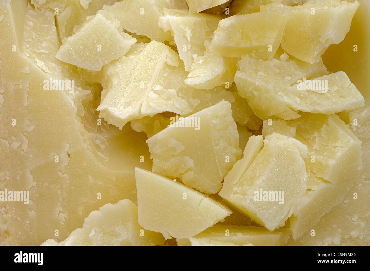 Hard Parmesan cheese, chopped into pieces. Close up shot, abstract ...