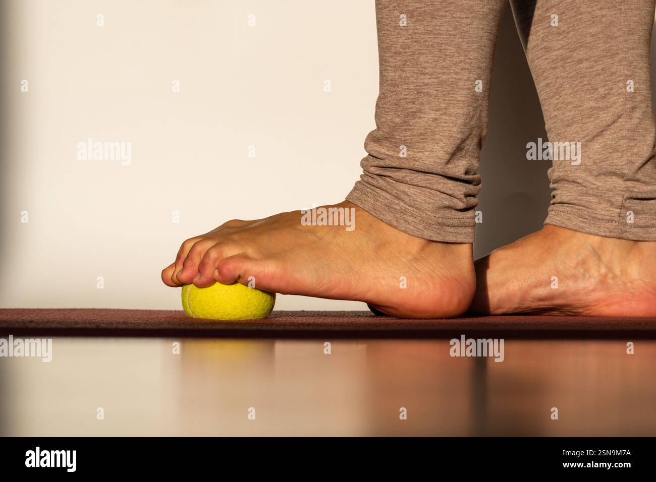 Myofascial relaxation of the muscles of the foot with a tennis ball on ...