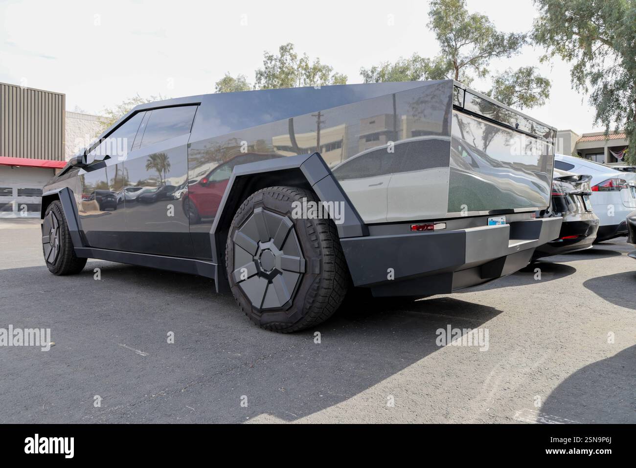 Telsa EV cars and a Cybertruck are parked at a Tesla Service Station on ...