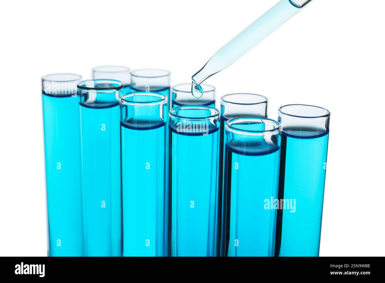Dripping liquid into test tubes on white background Stock Photo - Alamy