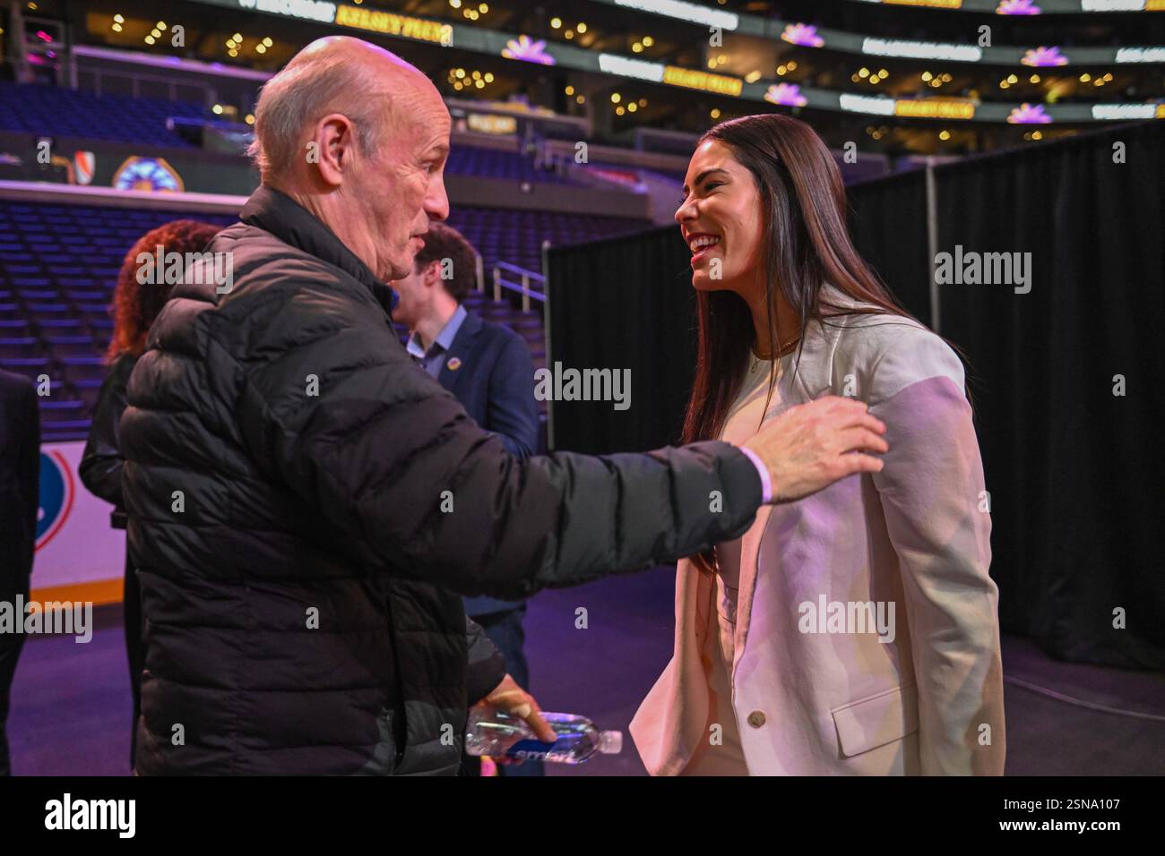 Los Angeles Dodgers president Stan Kasten hugs Kelsey Plum after a ...
