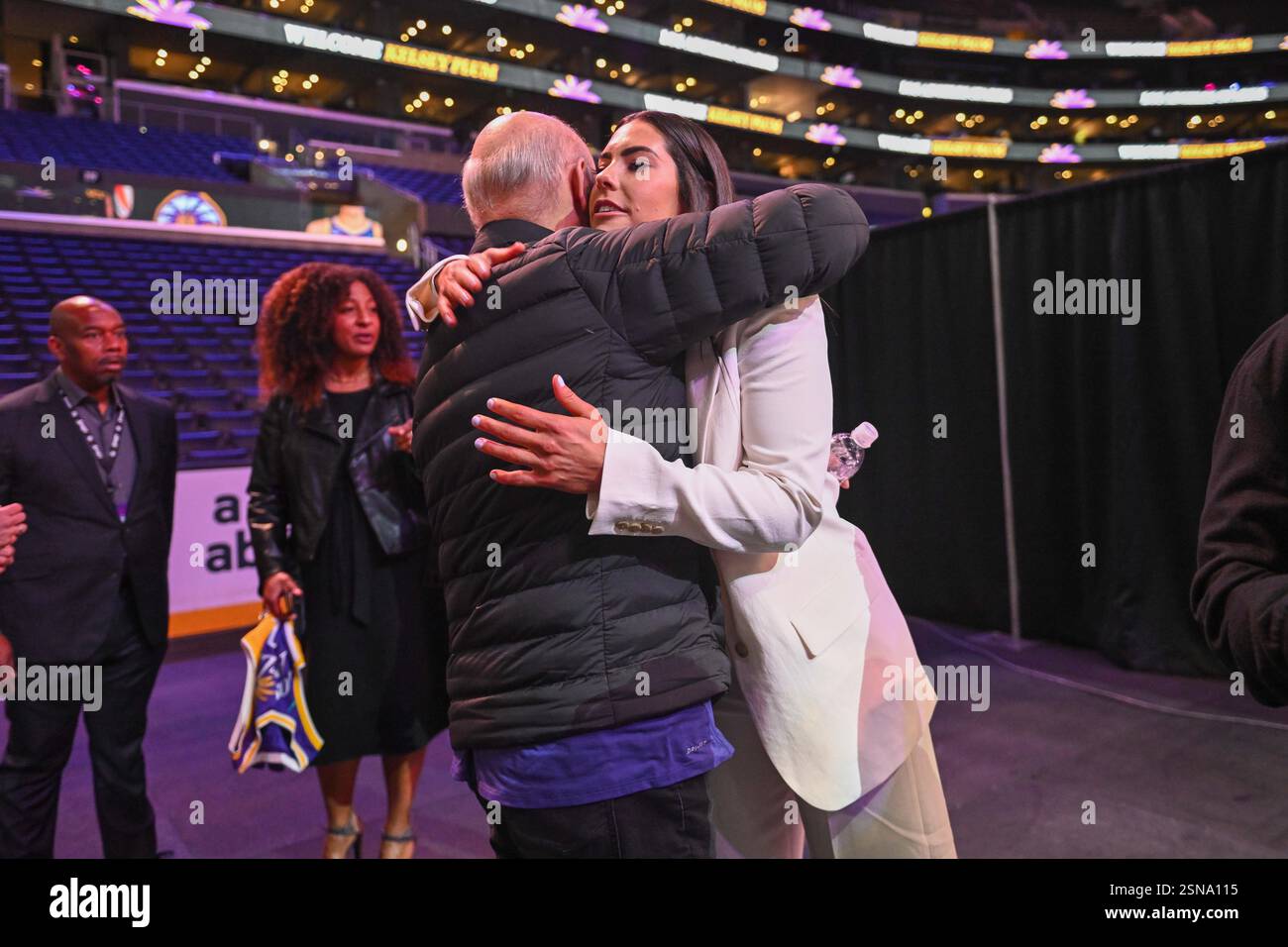 Los Angeles Dodgers president Stan Kasten hugs Kelsey Plum after a ...