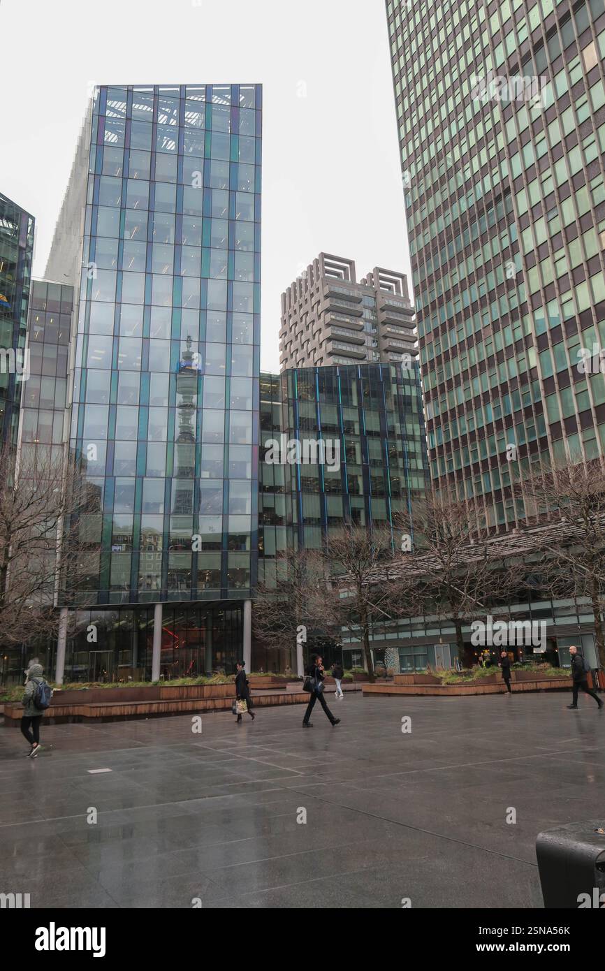 People walking across Triton Square in London in front of glass fronted ...