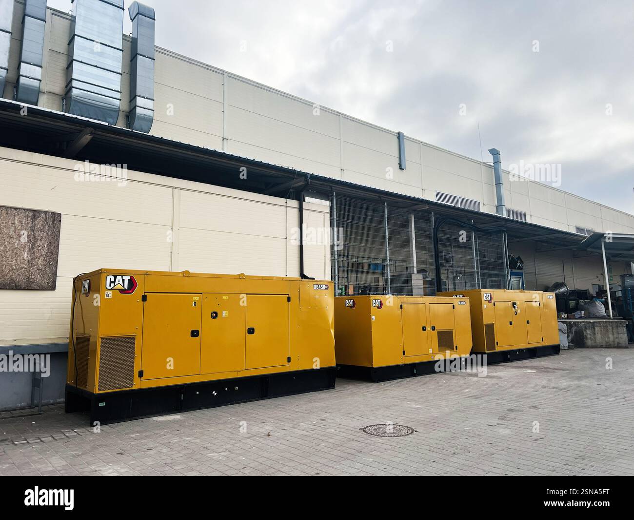 Lviv, Ukraine - February 12, 2025: Multiple industrial CAT generators ...