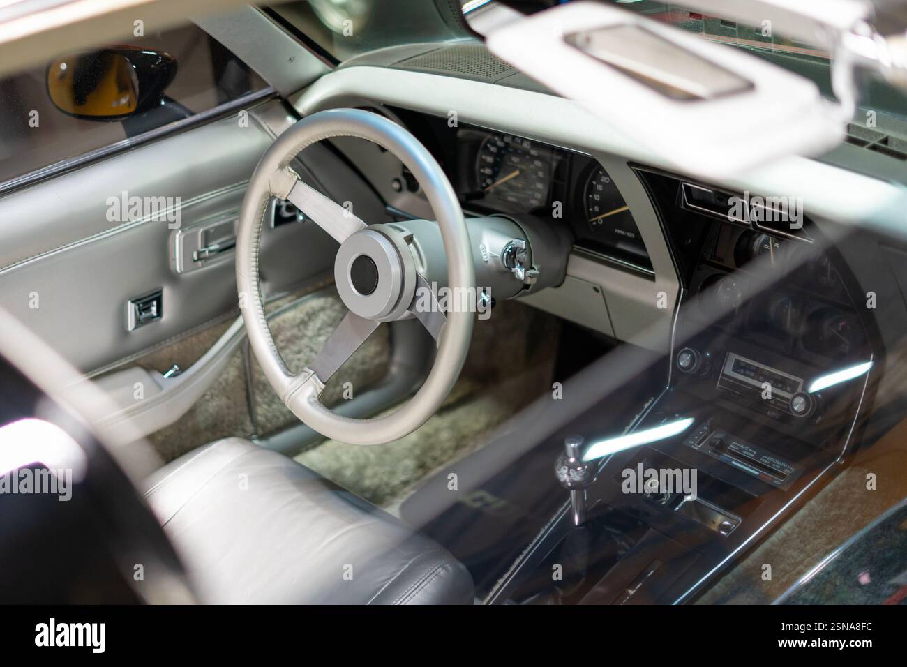 A close-up view of a vintage sports car interior, featuring a classic ...