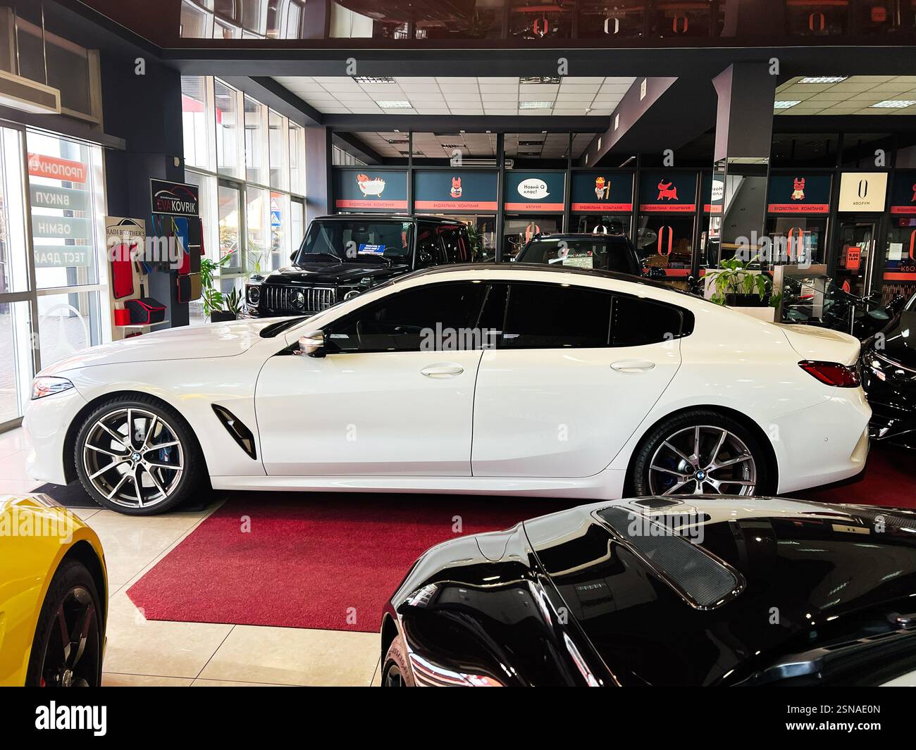 Lviv, Ukraine - February 12, 2025: Luxury white BMW M850 vehicle displayed in dealership ...