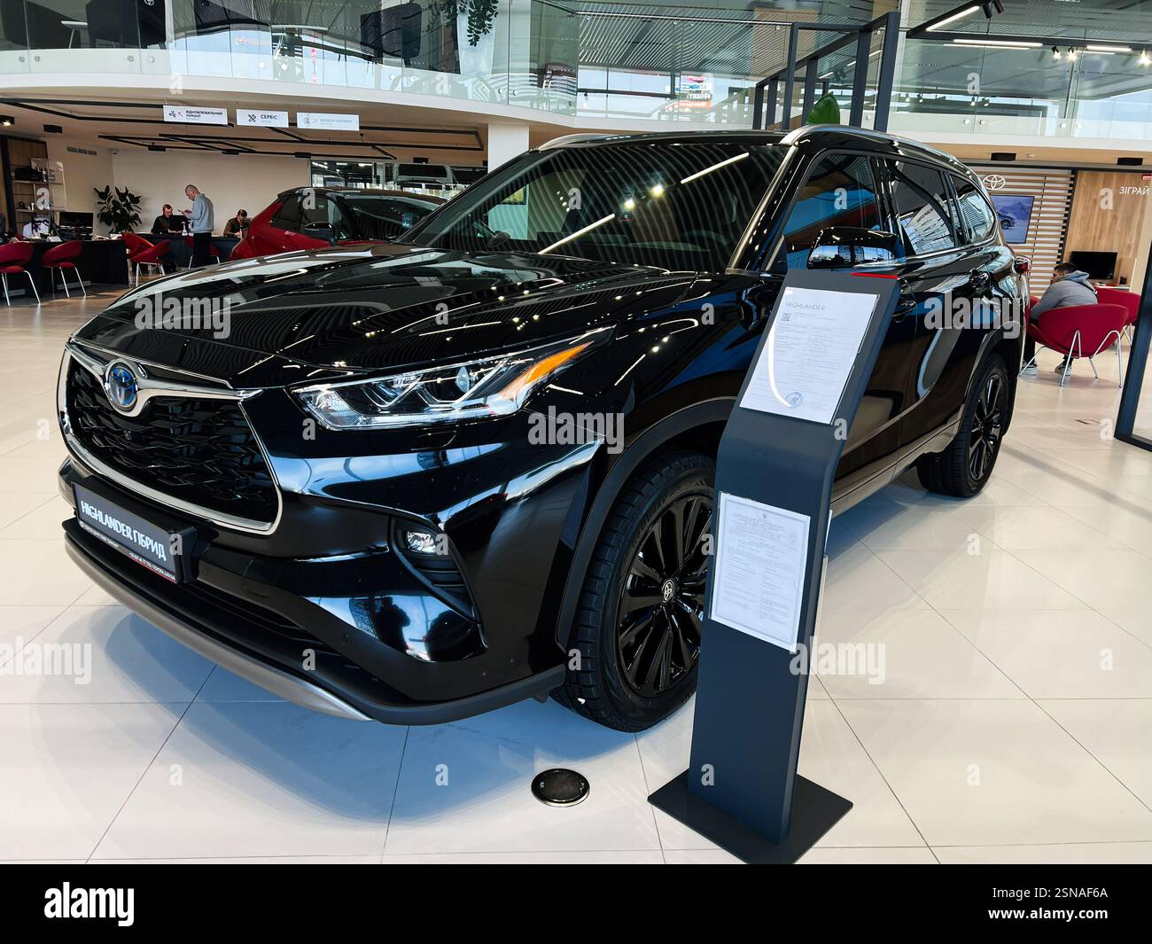 Lviv, Ukraine - February 12, 2025: Black Toyota Highlander Hybrid SUV showcased in a showroom ...