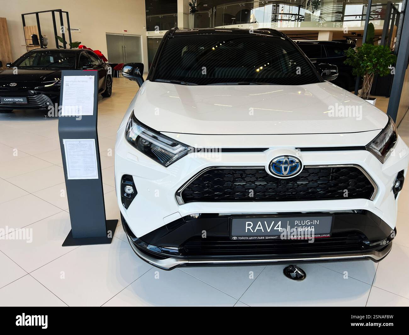 Lviv, Ukraine - February 12, 2025: White plug-in hybrid Toyota RAV4 car ...