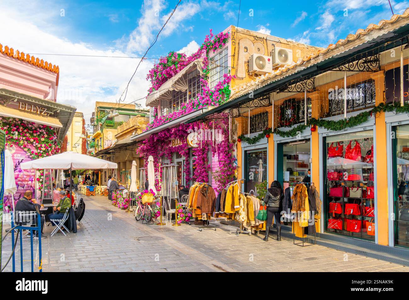 Colorfully decorated shops covered with flowers and sidewalk cafes in ...