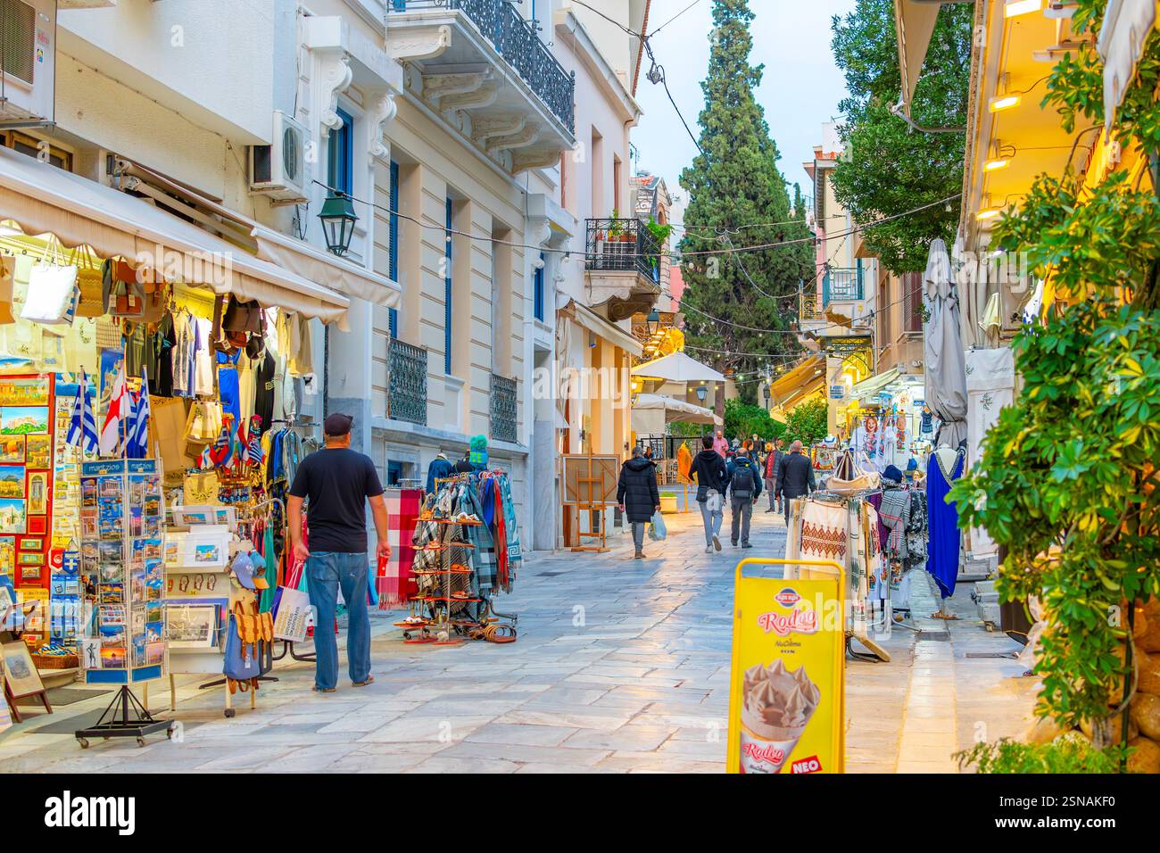A colorful pedestrian street of shops and cafes at twilight in the ...