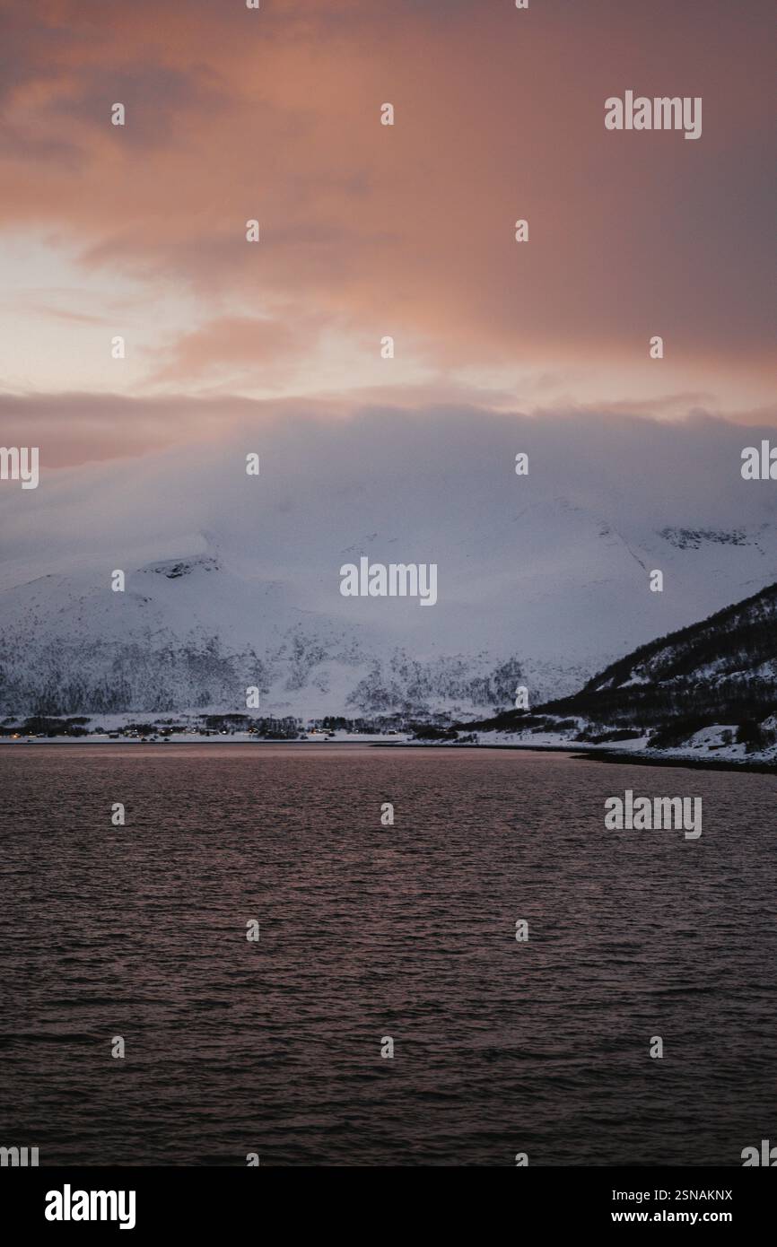 Snowy mountains under clouds at golden hour in northern Norway Stock ...