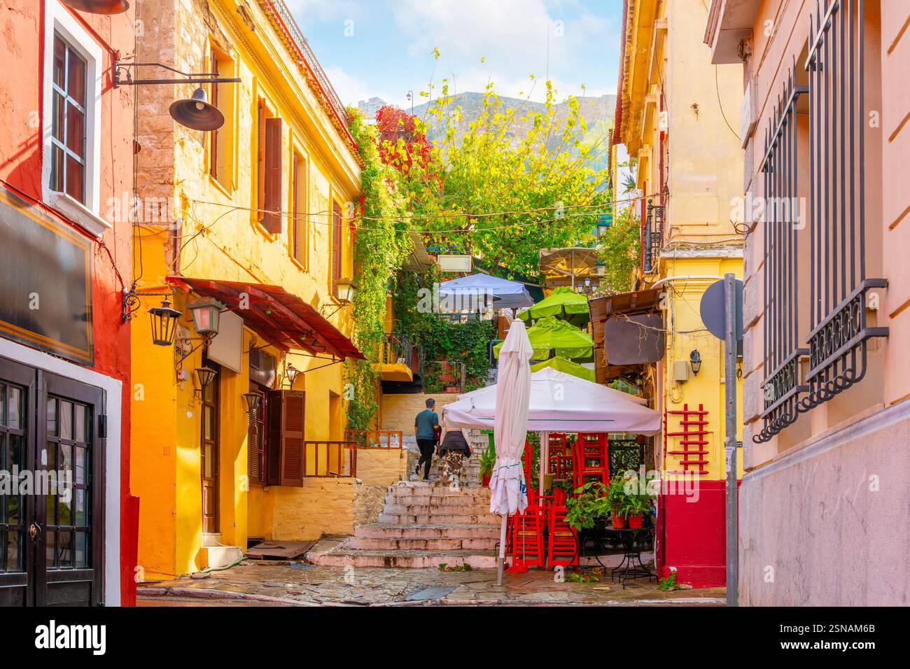 Colorful buildings with sidewalk cafes and shops near the Plaka Stairs ...