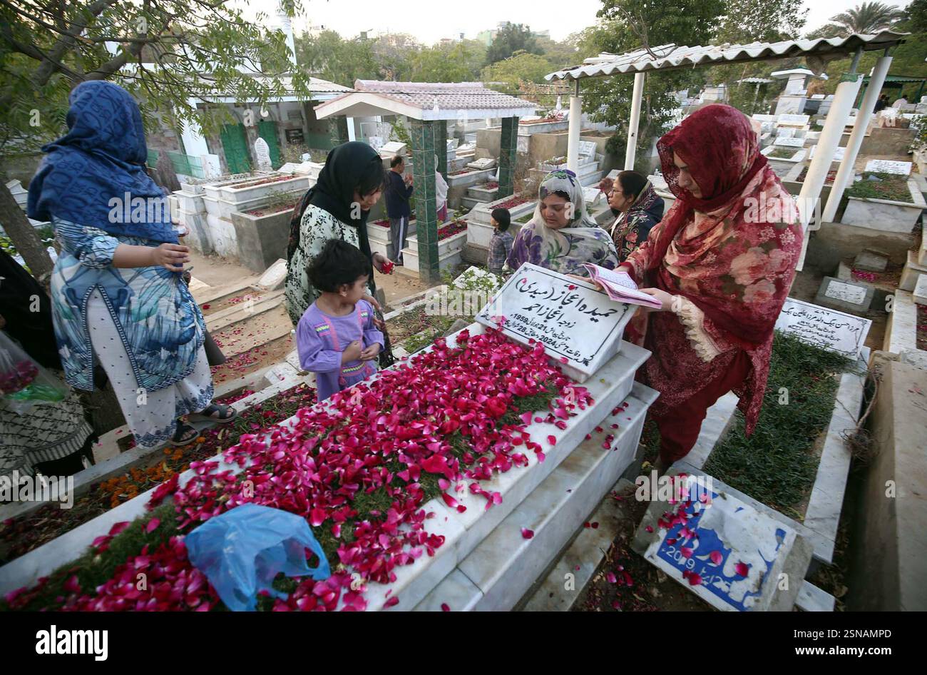 Family members are laying rose petals and offering Fateha on their ...