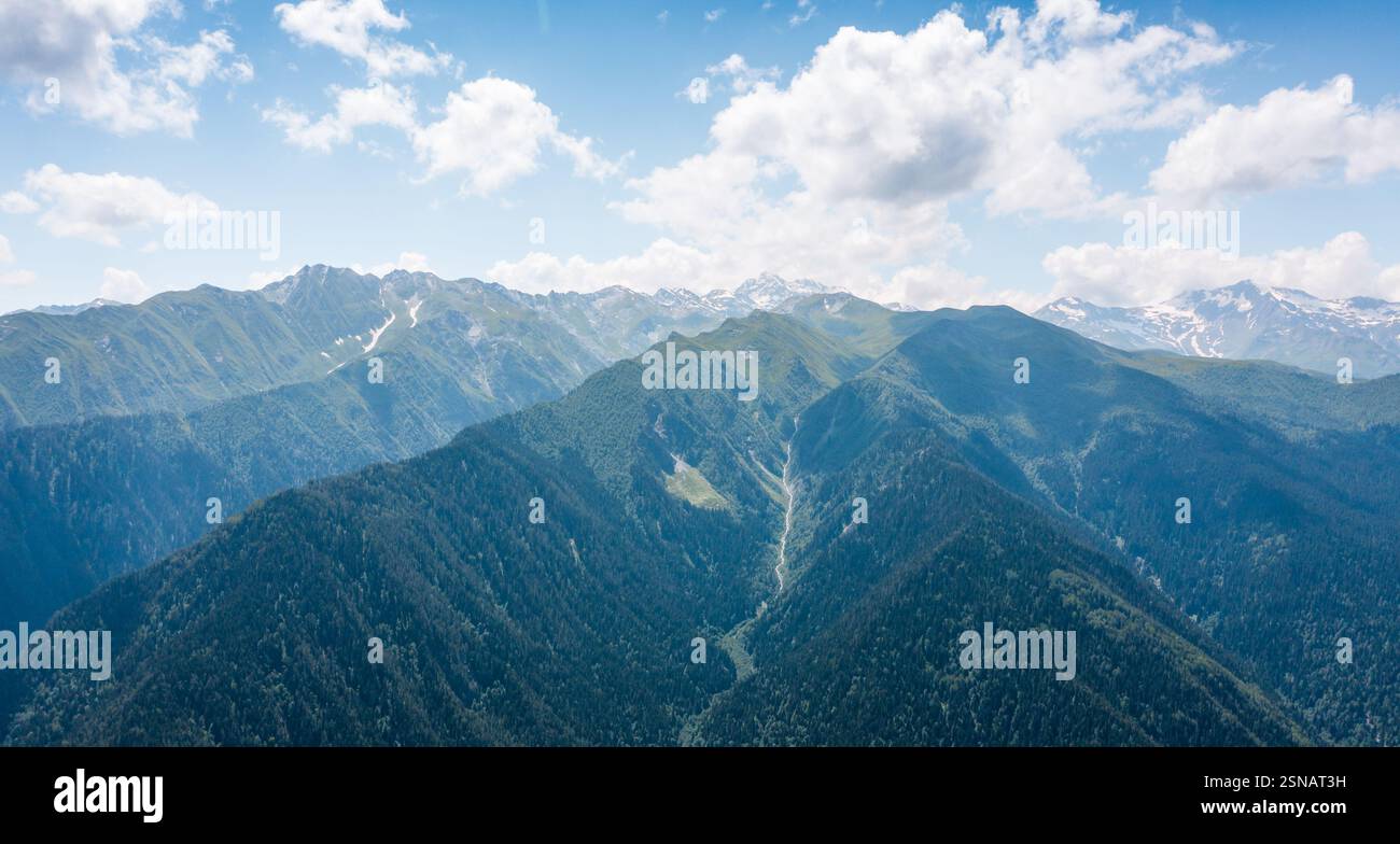 Breathtaking view of towering mountain ridges with snow-capped peaks ...