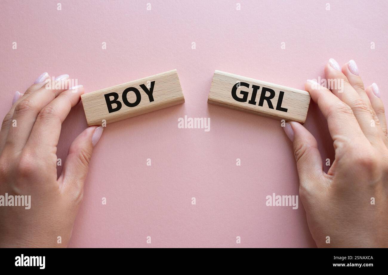 Boy or Girl symbol. Concept word Boy or Girl on wooden blocks. Man hand ...